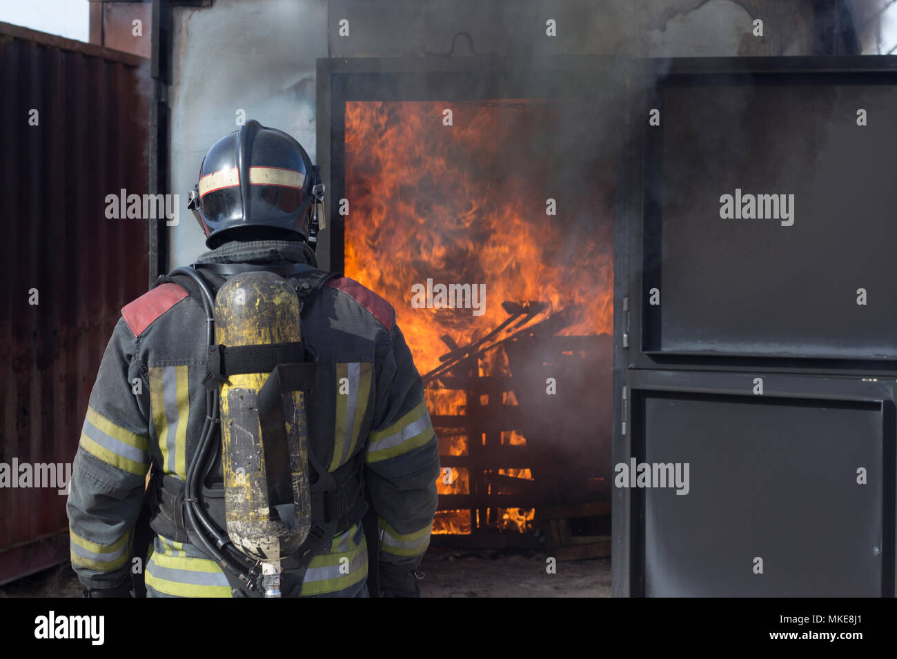 Firefighter putting out fire training station extinguisher backdraft ...