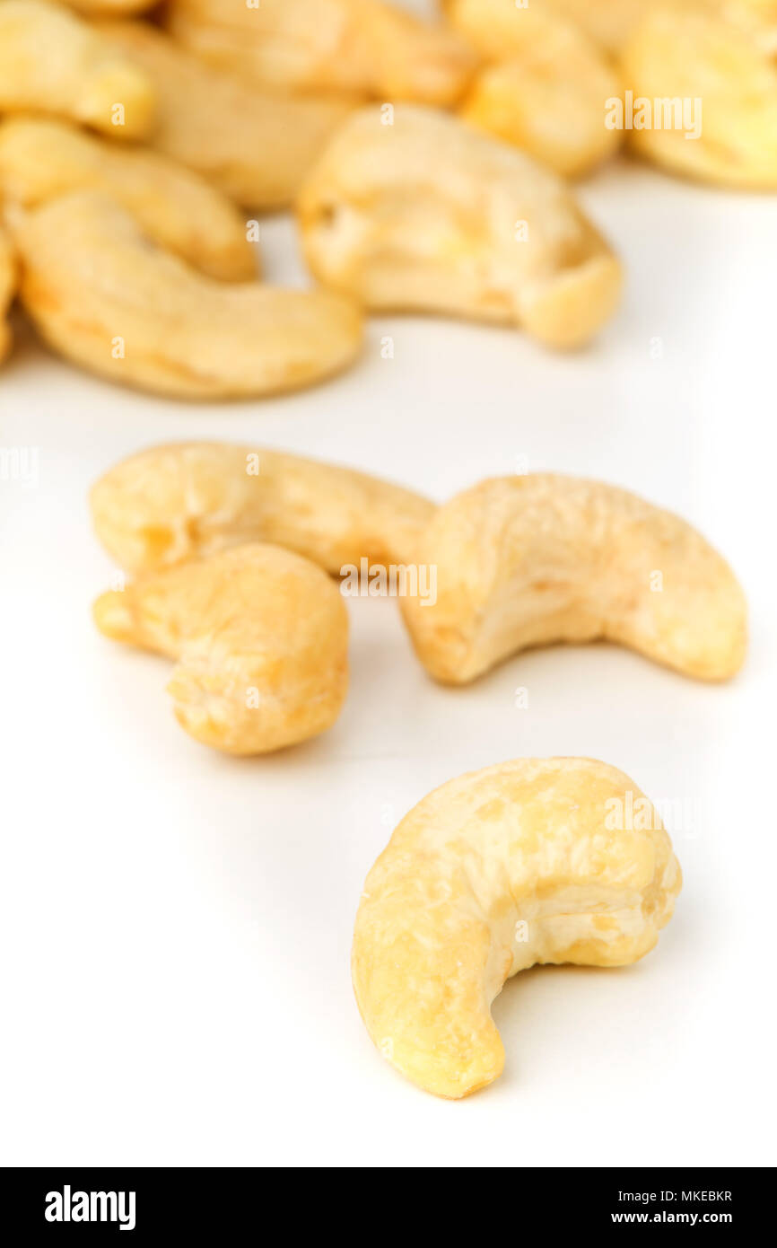 Close up of raw, organic, whole cashew nut kernels over white ...