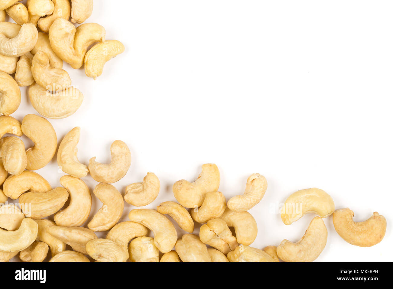 Corner of raw, organic, whole cashew nut kernels over white background ...