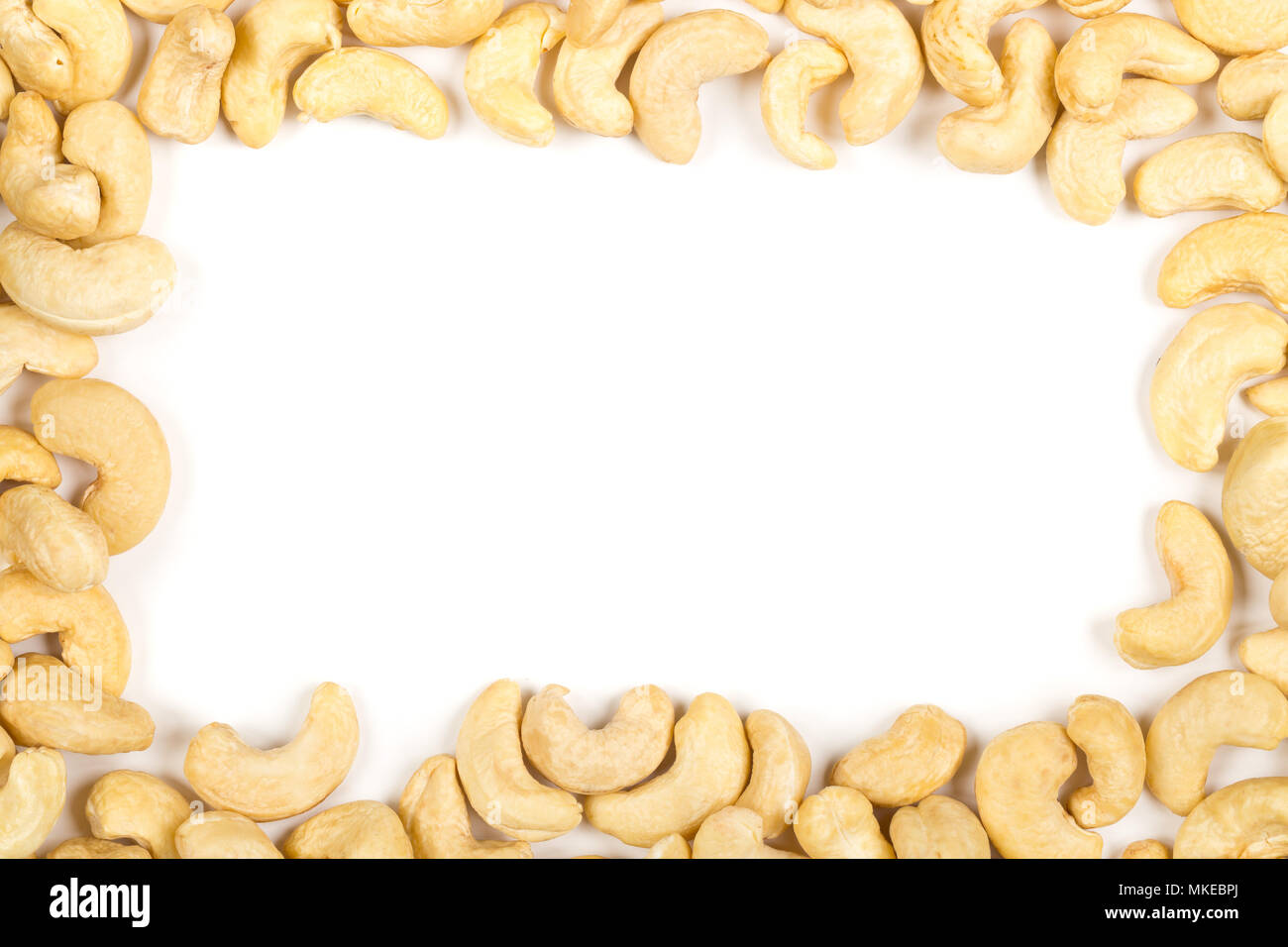 Frame of raw, organic, whole cashew nut kernels over white background ...