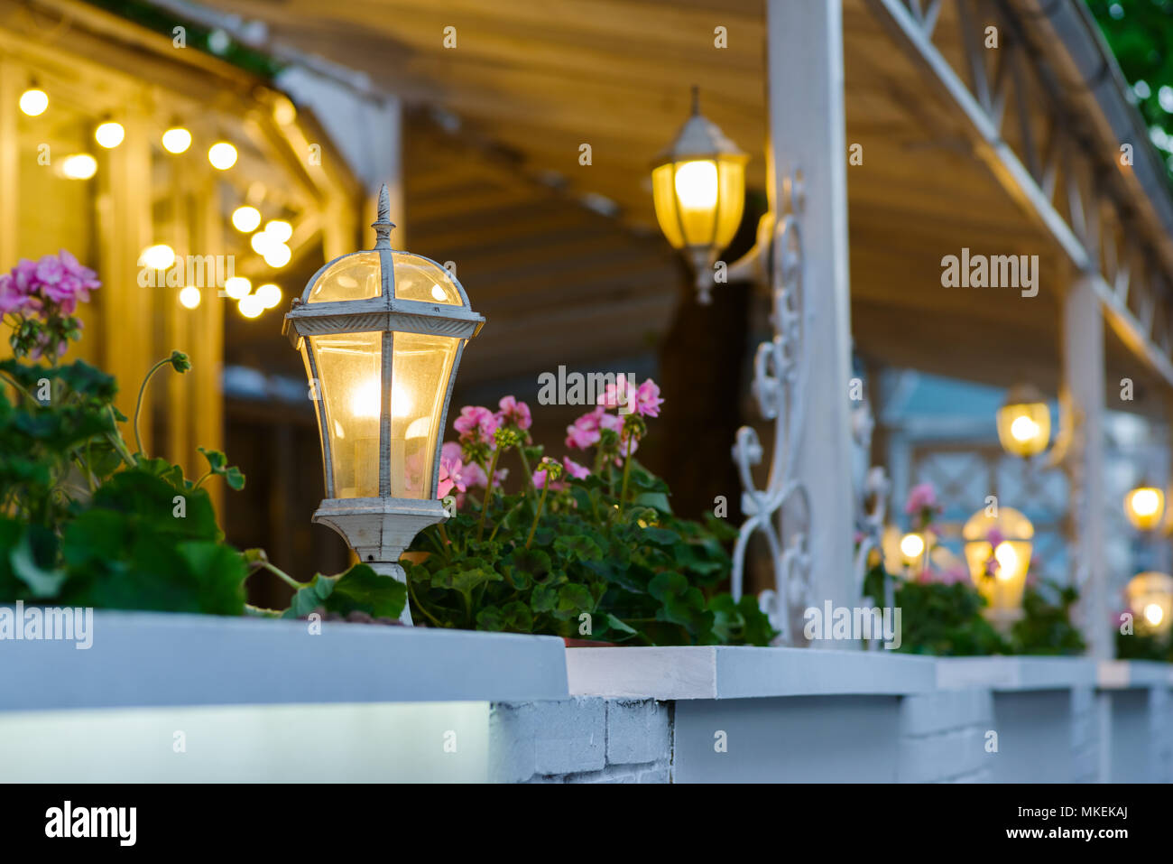 decorative street lamps decorating a summer terrace with forged ...