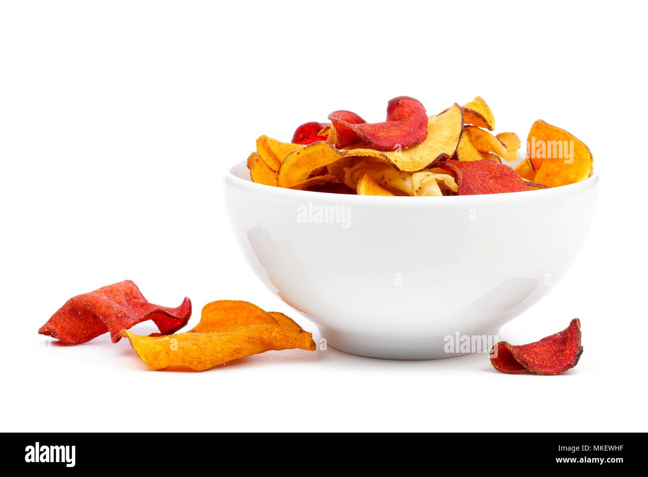 Bowl of mixed healthy vegetable chips. Side view, isolated on a white ...
