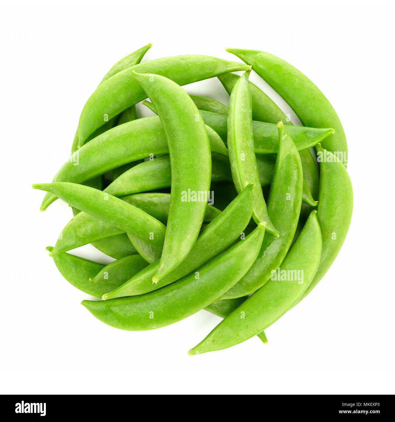 Pile of fresh snap peas. Above view isolated on a white background ...