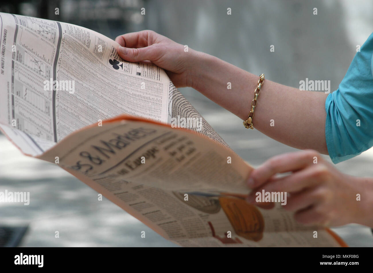 woman reading the latest news and markets in a newspaper Stock Photo ...