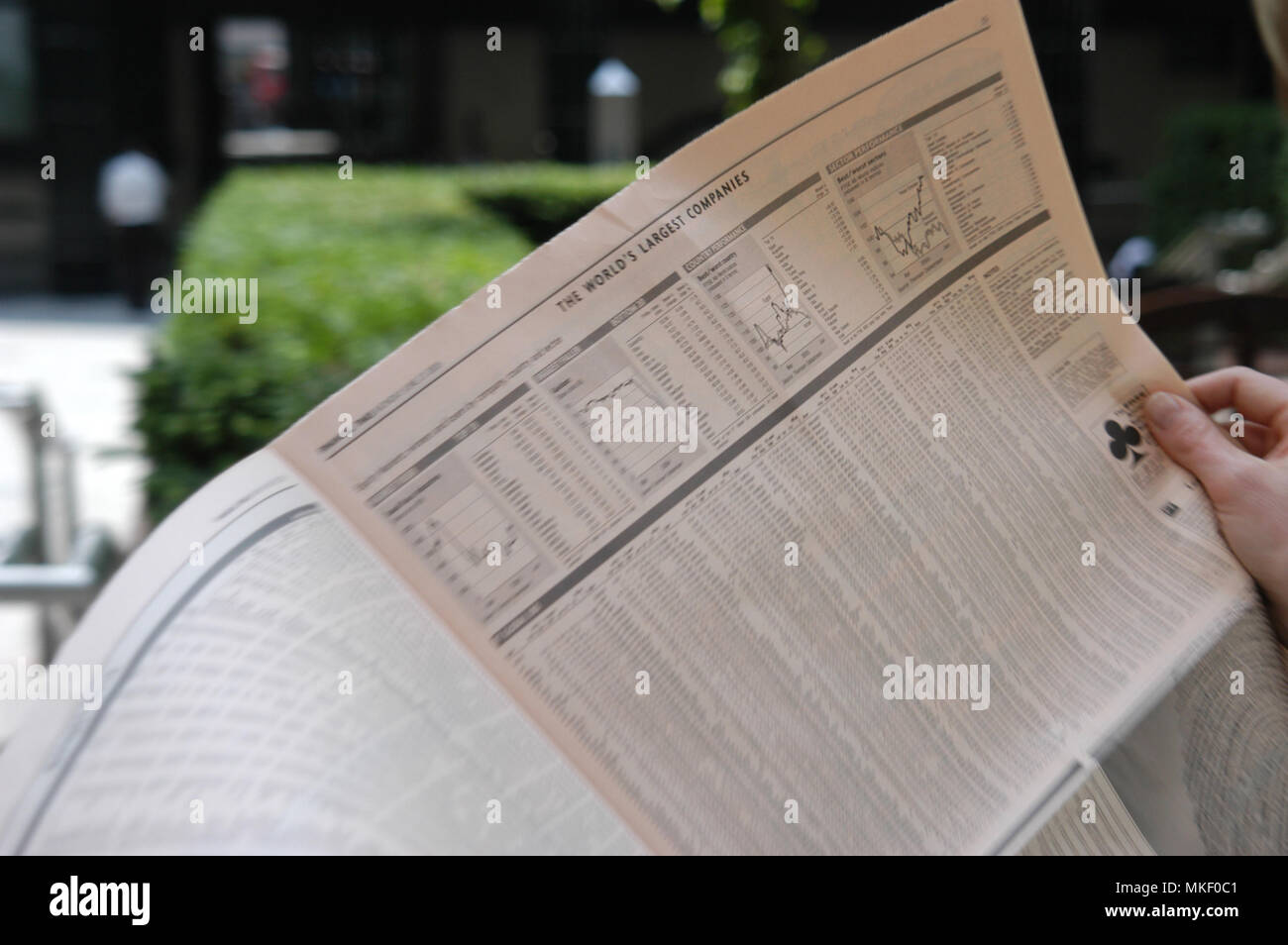 Closeup of open pages with womans hand when she is reading the latest ...