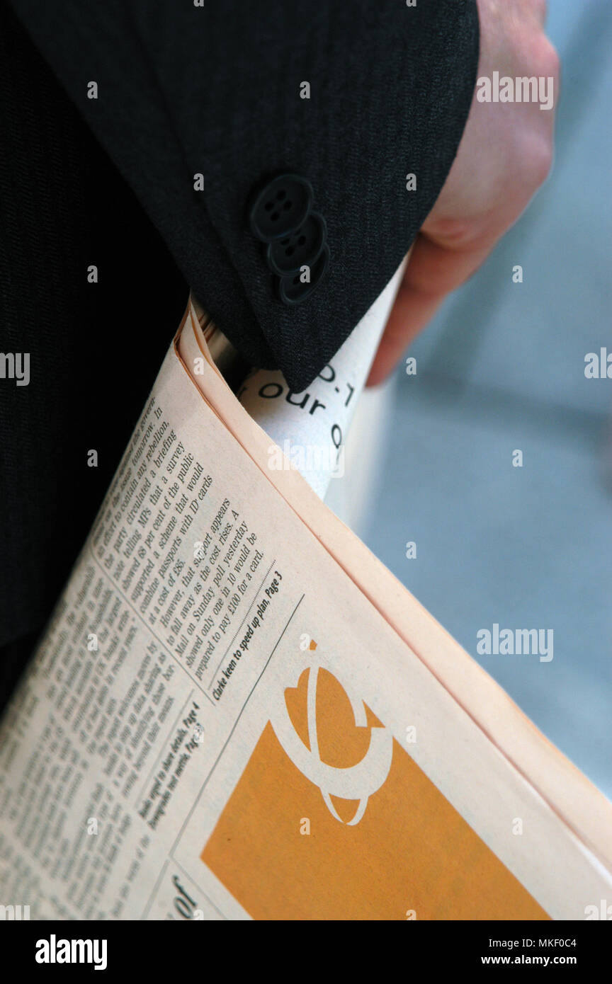 man holding newspaper containing the latest news in a newspaper Stock ...
