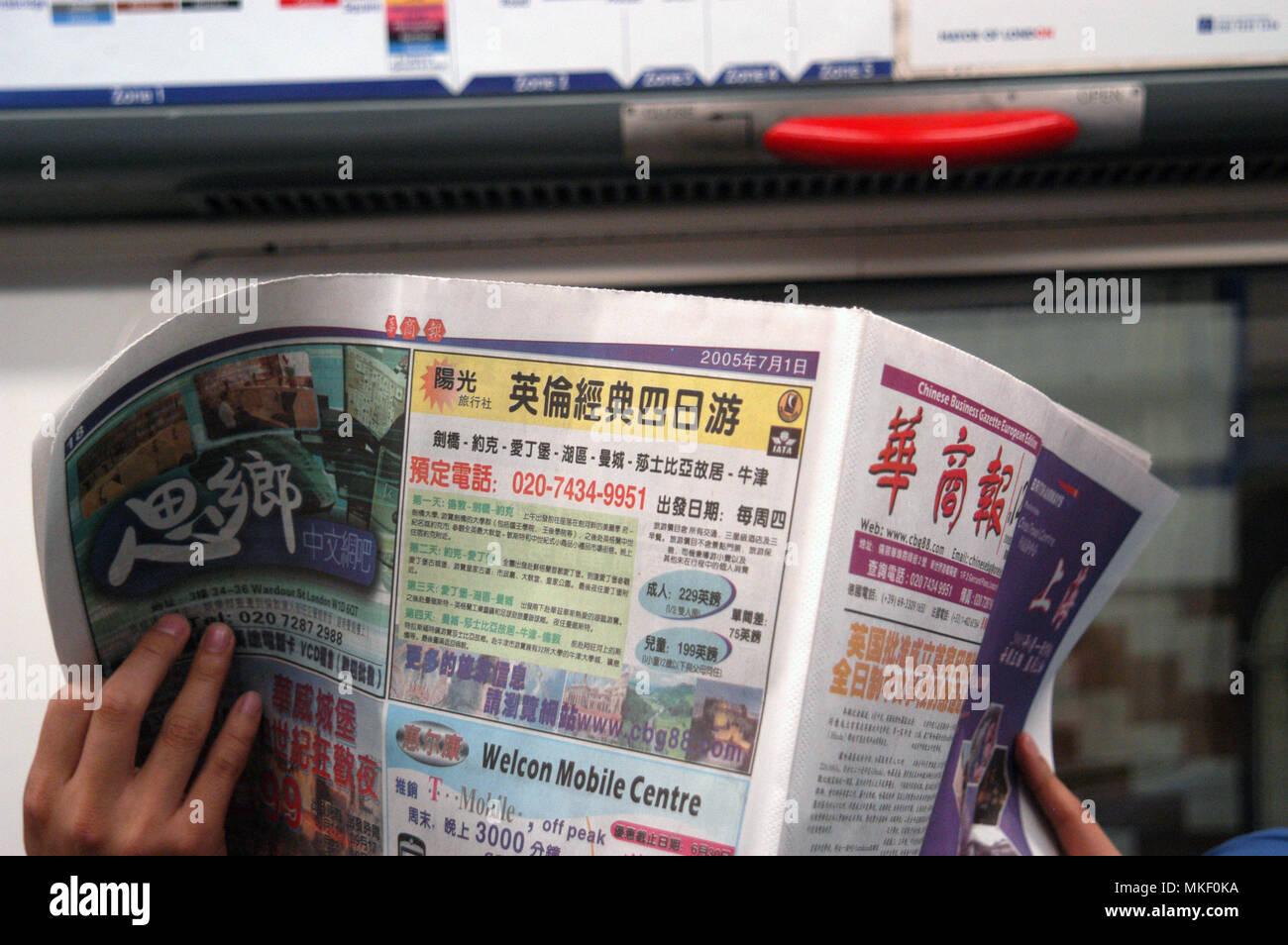 Tube commuters time, man commuting and reading asian newspaper on the ...