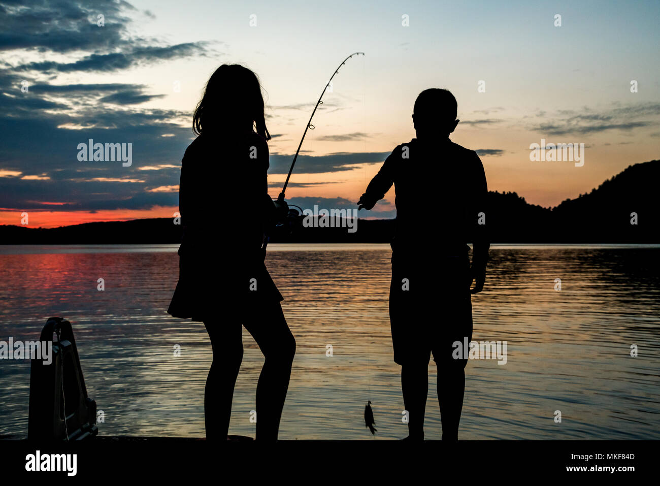 Boy fishing off dock in hi-res stock photography and images - Alamy