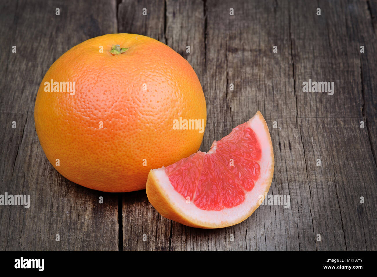 Fresh red grapefruit on rustic wood background Stock Photo - Alamy