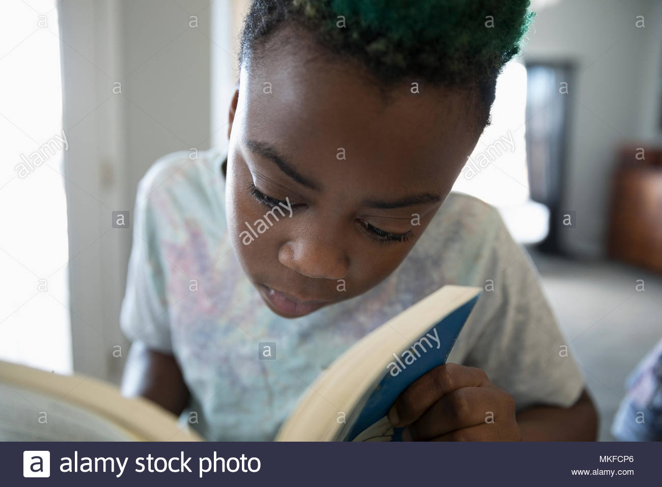 African boy reading book hi-res stock photography and images - Alamy