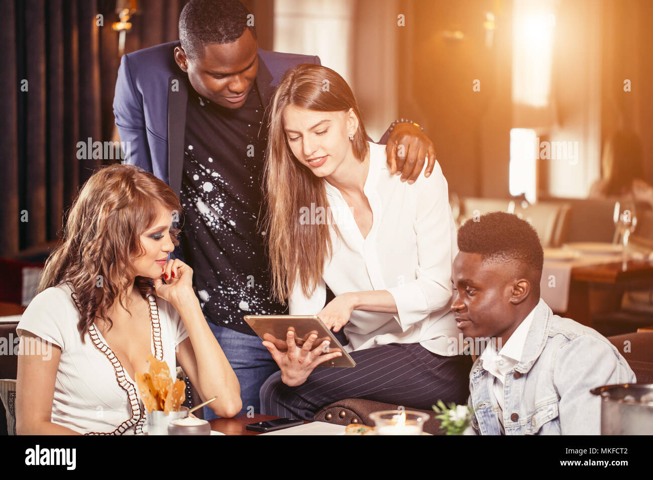 Long haired young female showing on laptop interesting moments of ...