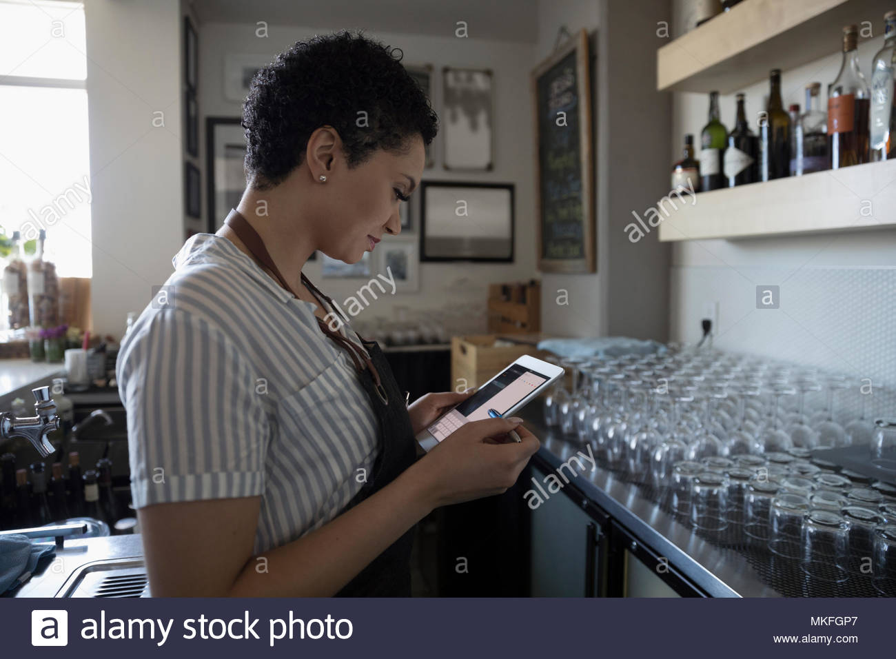 Business woman holding and working with a tablet, isolated over a white ...