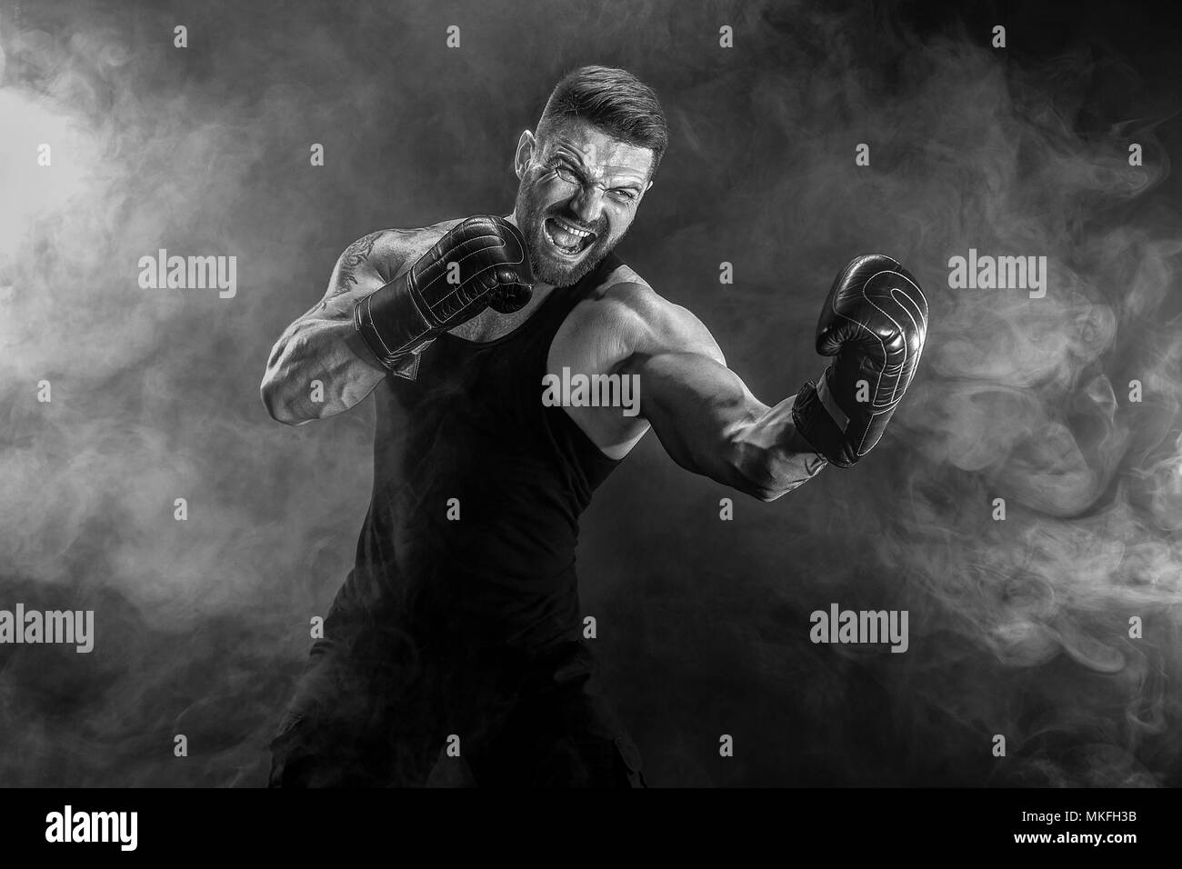 Sport concept. Sportsman muay thai boxer fighting on black background ...