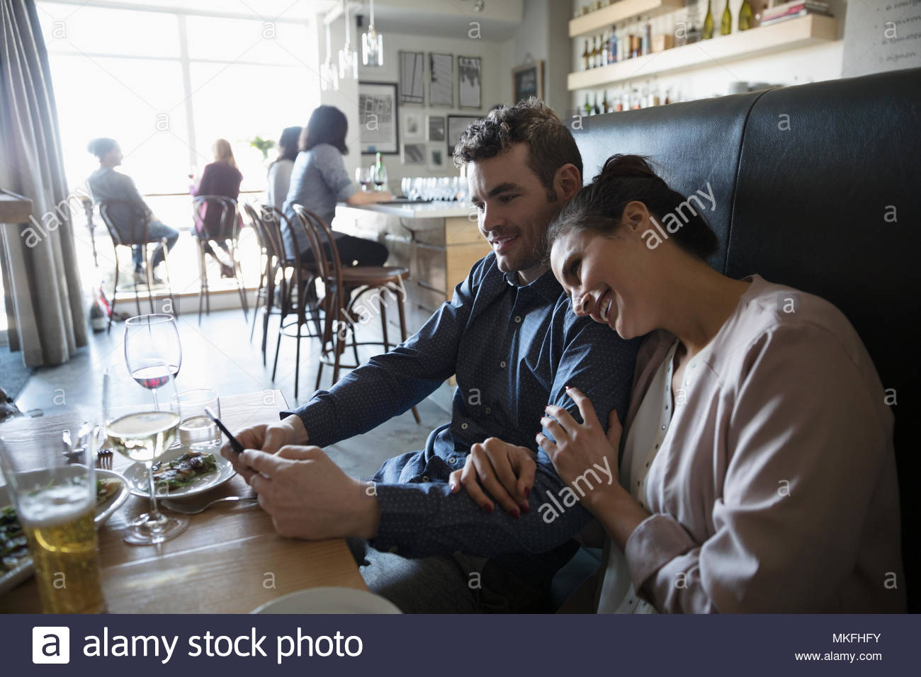 Two women sitting at a table in a bar hi-res stock photography and ...