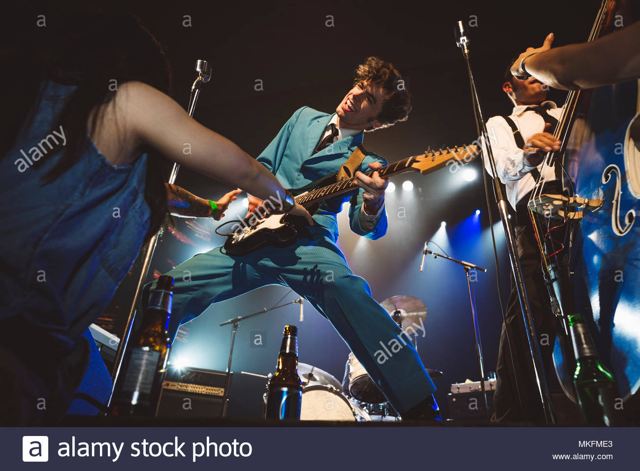 Arts culture and entertainment holding guitar skill standing microphone ...