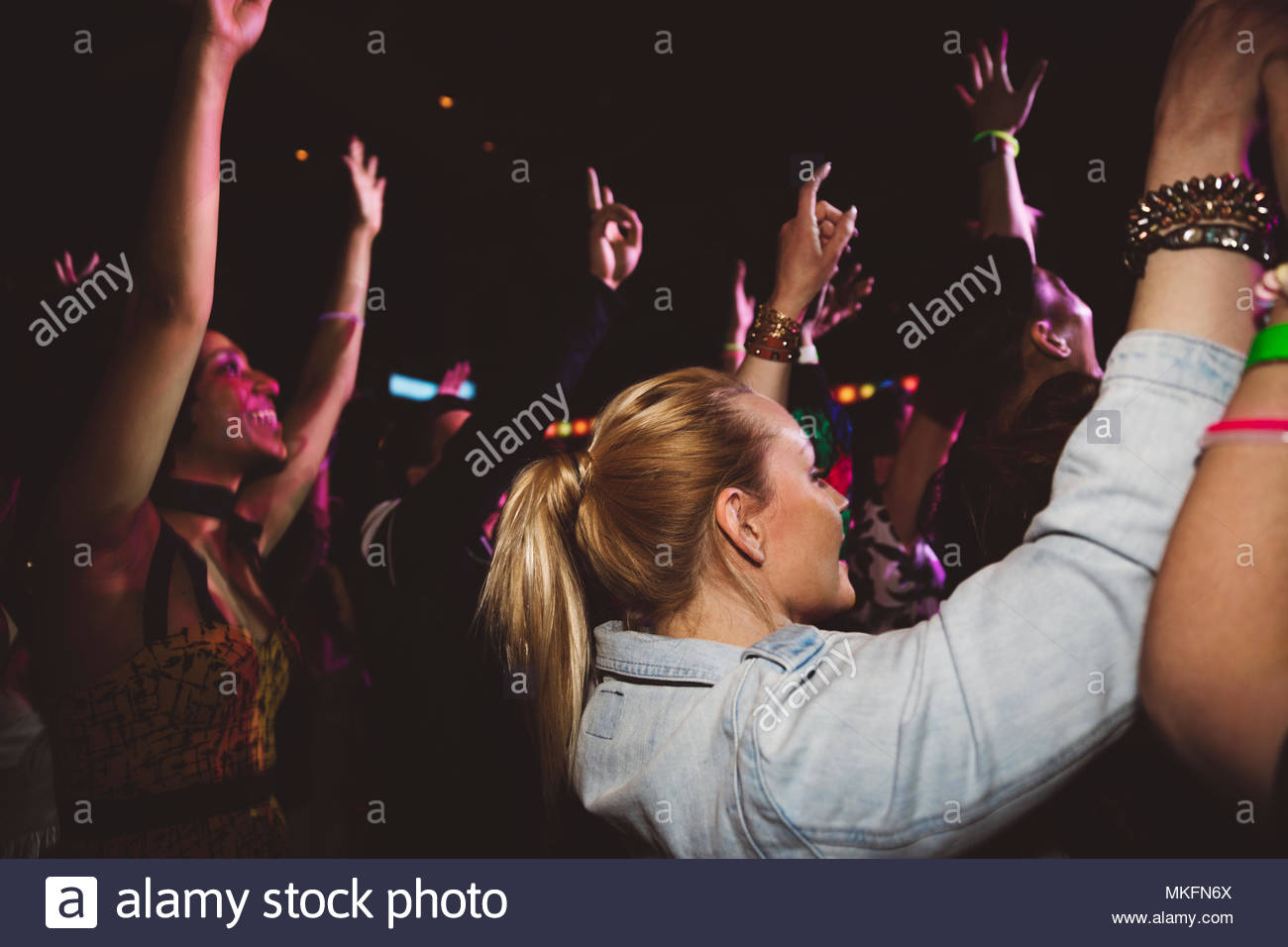 Crowd dancing and cheering at music concert in nightclub Stock Photo ...