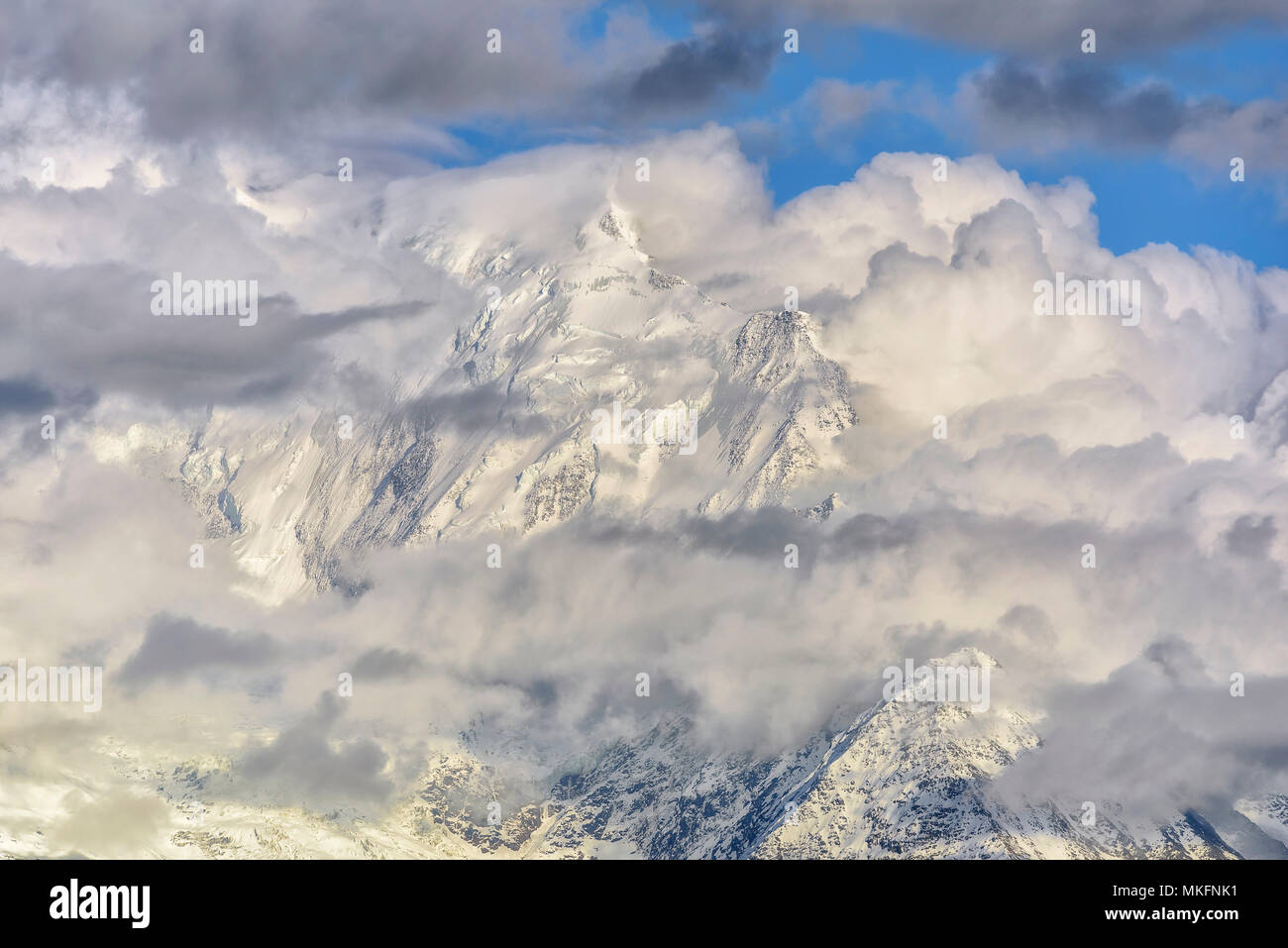Bionnassay needle under clouds at dusk on a stormy evening, Mont Blanc ...