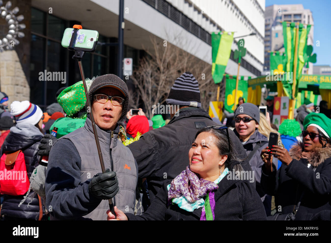 An asian couple pose for a selfie at the Montreal St Patrick's Day ...