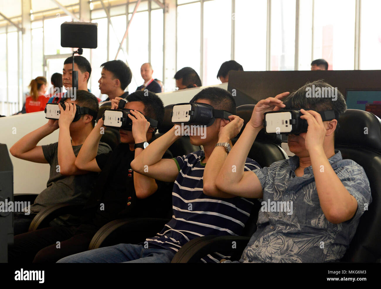 Visitors to the Auto China 2018 motor show in Beijing, China, don ...