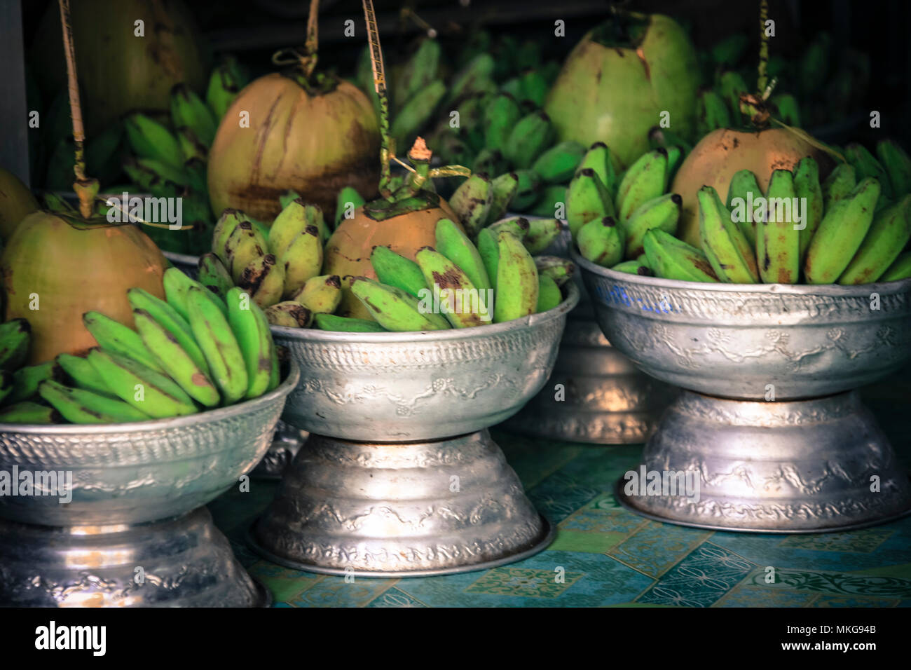 Green banana and coconut in pot for prayers in Buddhist and Hindu ...