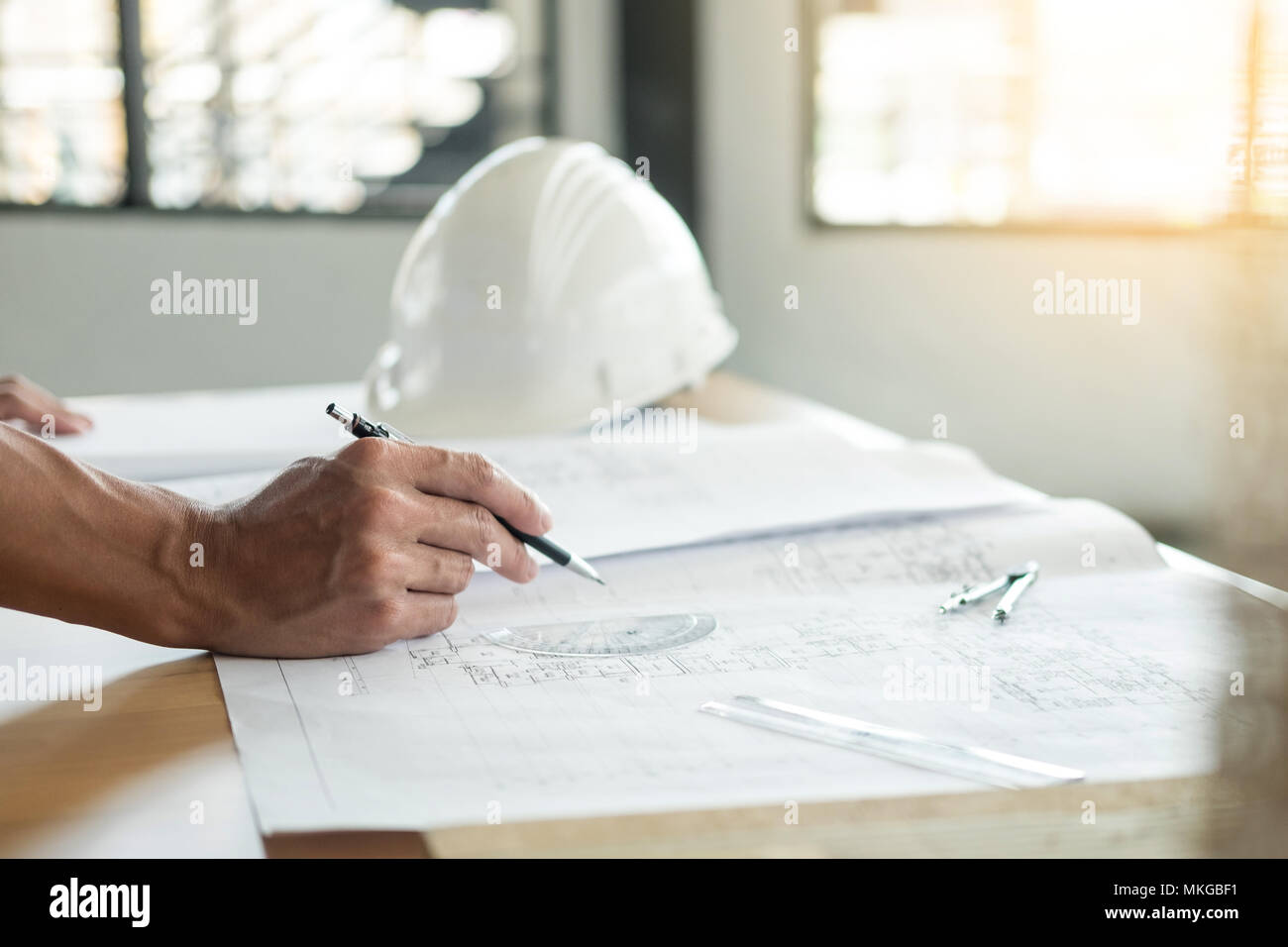 Person's engineer Hand Drawing Plan On Blue Print with architect ...