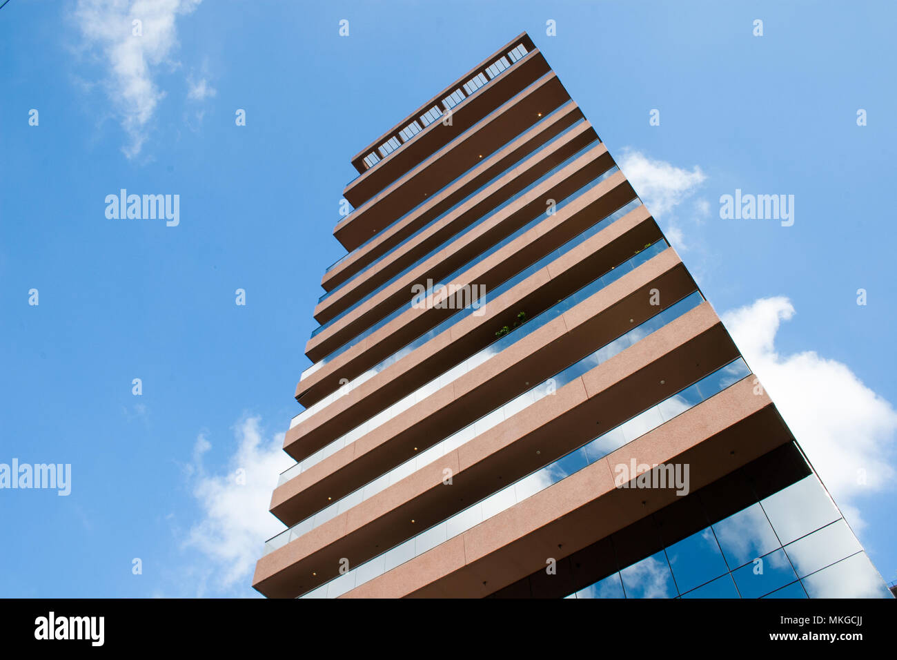 Low angle view of a residential building with terraces and a heliport ...