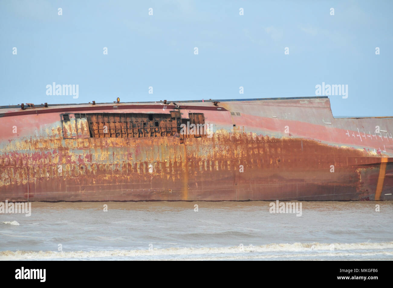 Blue sky view of Riverdance Ferry Wreck, lying on its side, surrounded ...