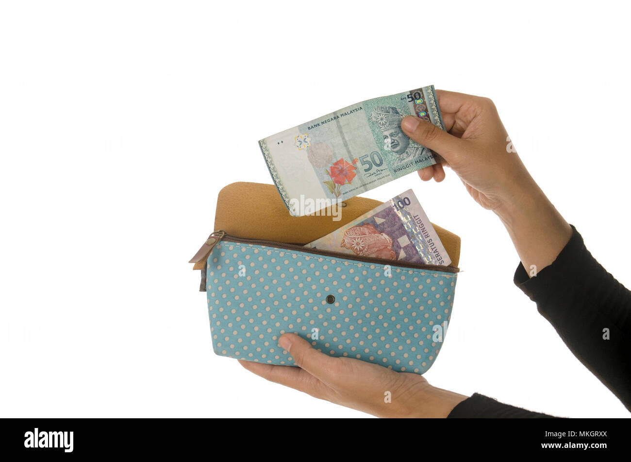 Woman hand put money in purse isolated on white background Stock Photo ...