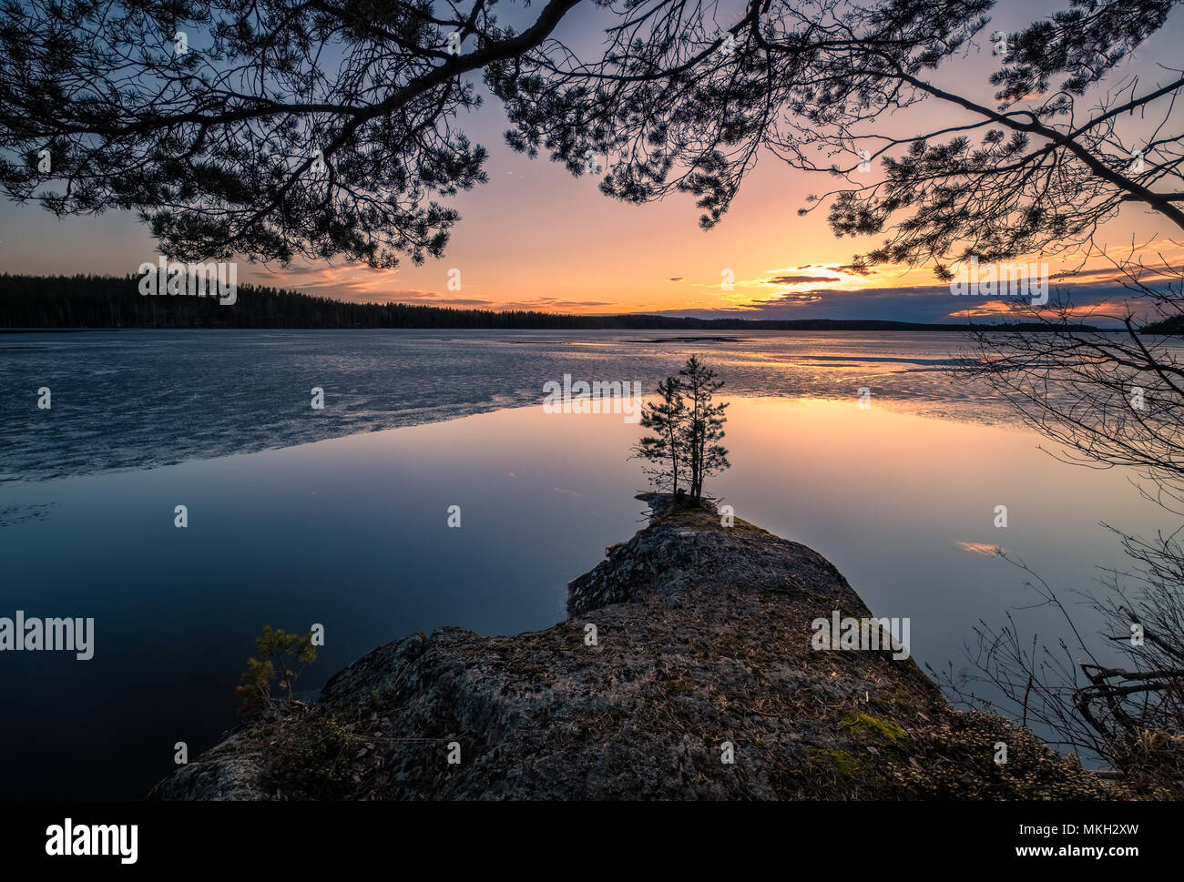 Scenic landscape with melting lake and sunset at beautiful spring ...