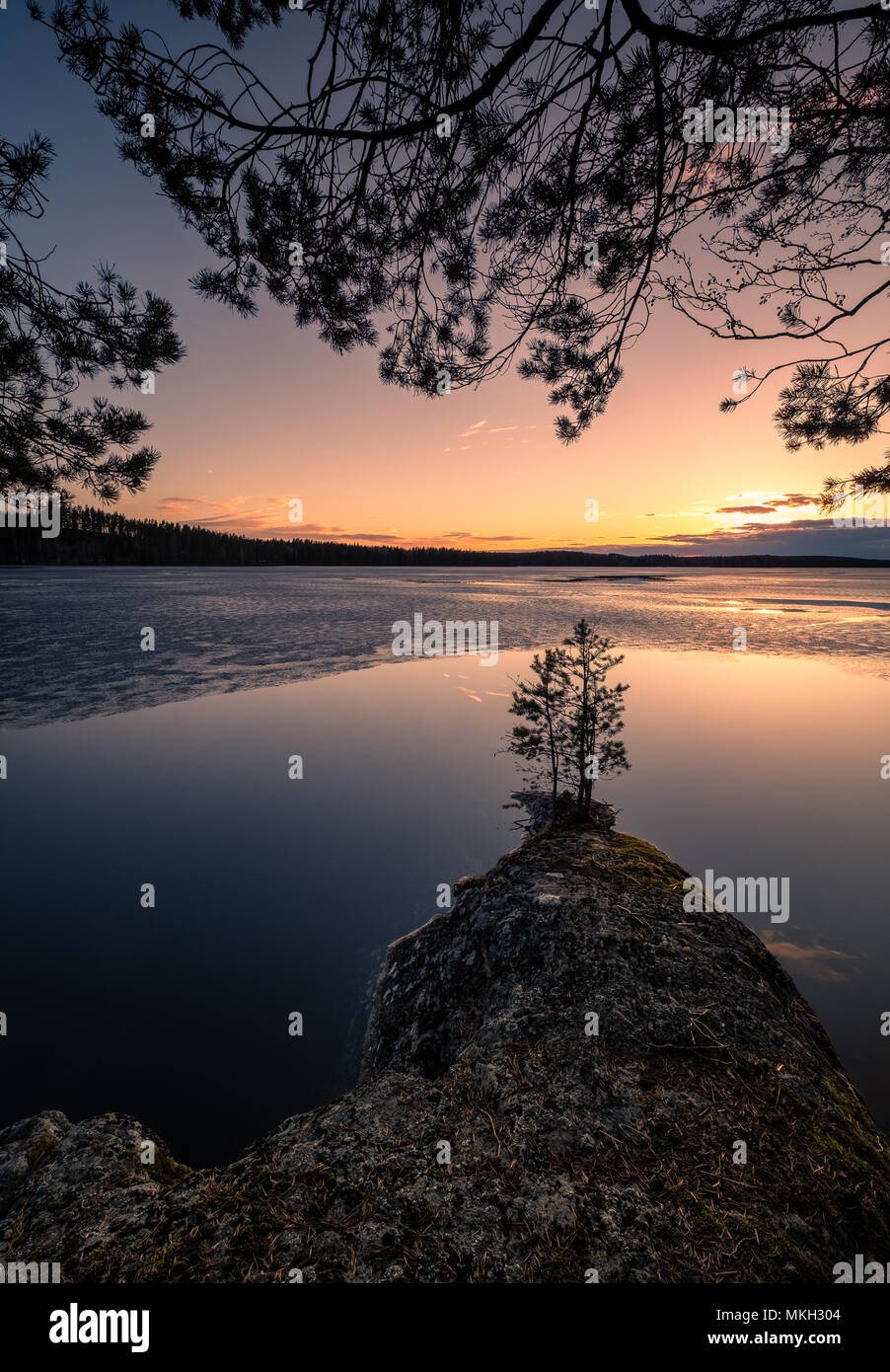 Scenic landscape with melting lake and sunset at beautiful spring ...