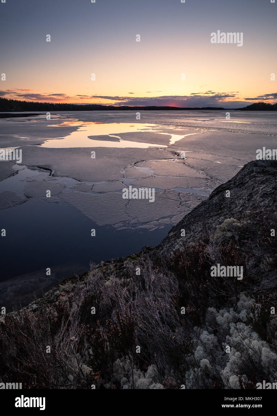 Scenic spring landscape with melted ice and sunset at evening light in ...