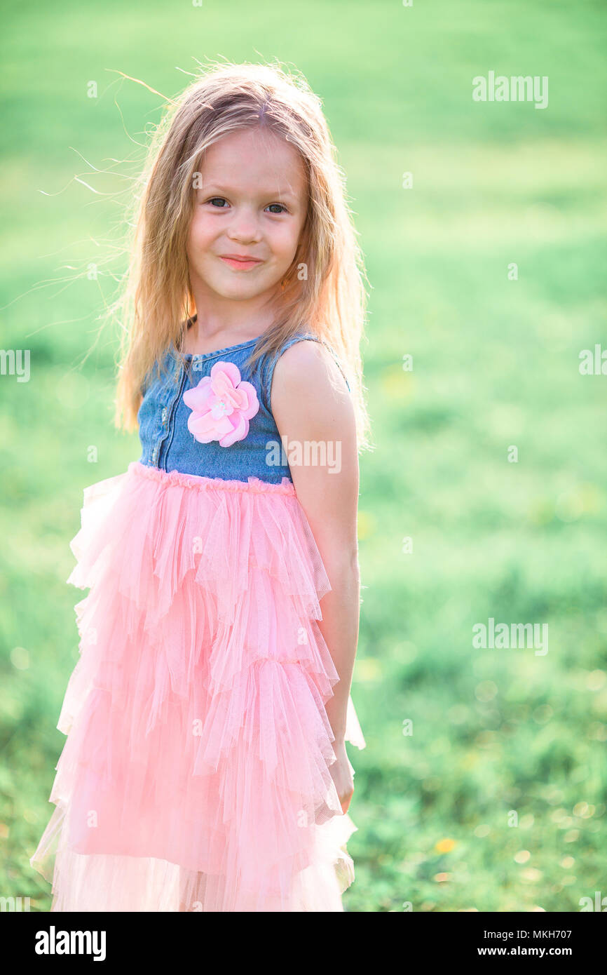 Adorable little girl enjoying spring day in apple blooming garden Stock ...