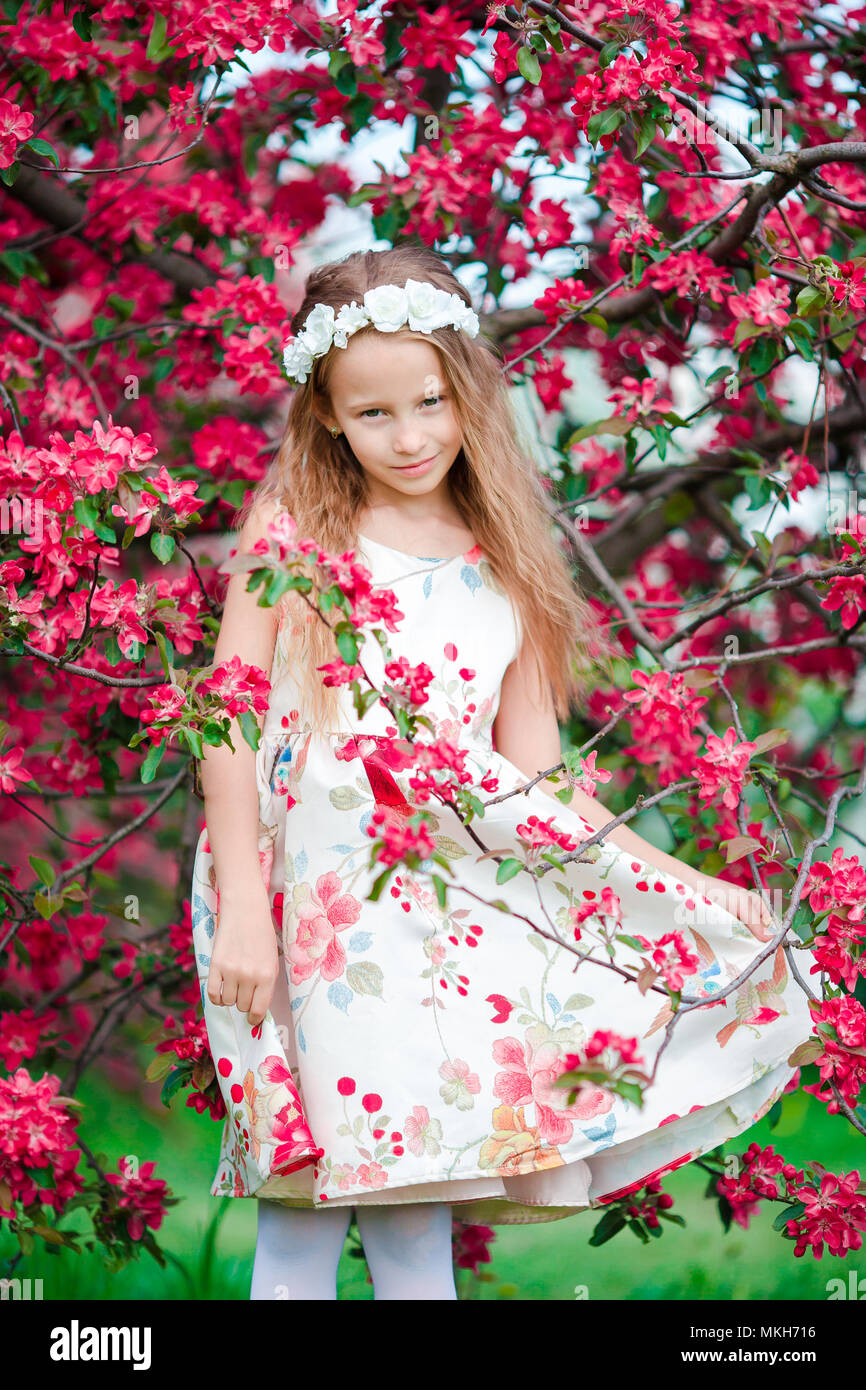 Adorable little girl in blooming apple tree garden on spring day Stock Photo - Alamy