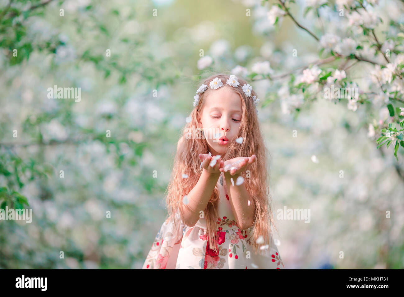 Adorable little girl in blooming cherry tree garden on spring day Stock Photo - Alamy