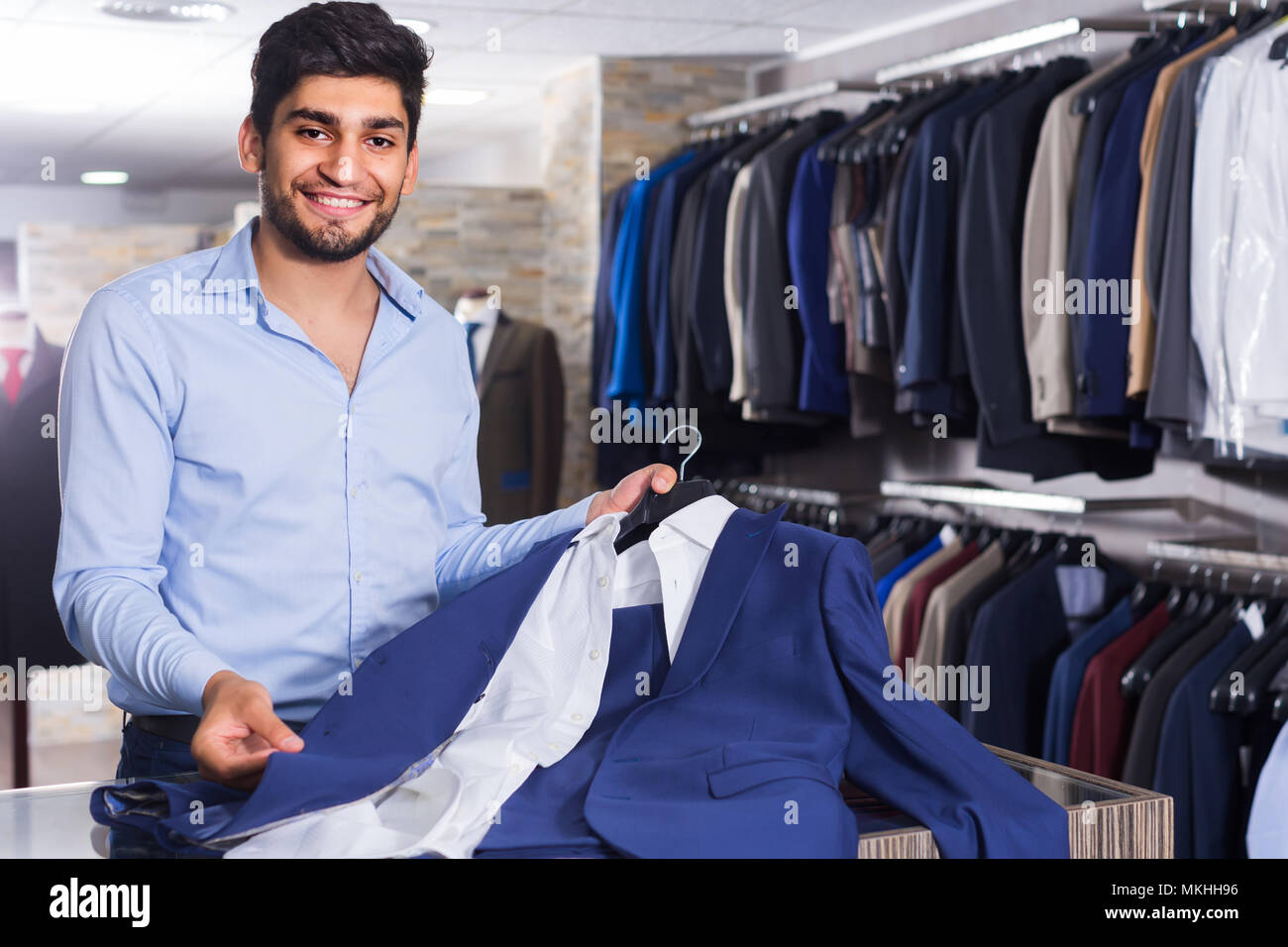 Man is demonstrating jacket and short indoors Stock Photo - Alamy