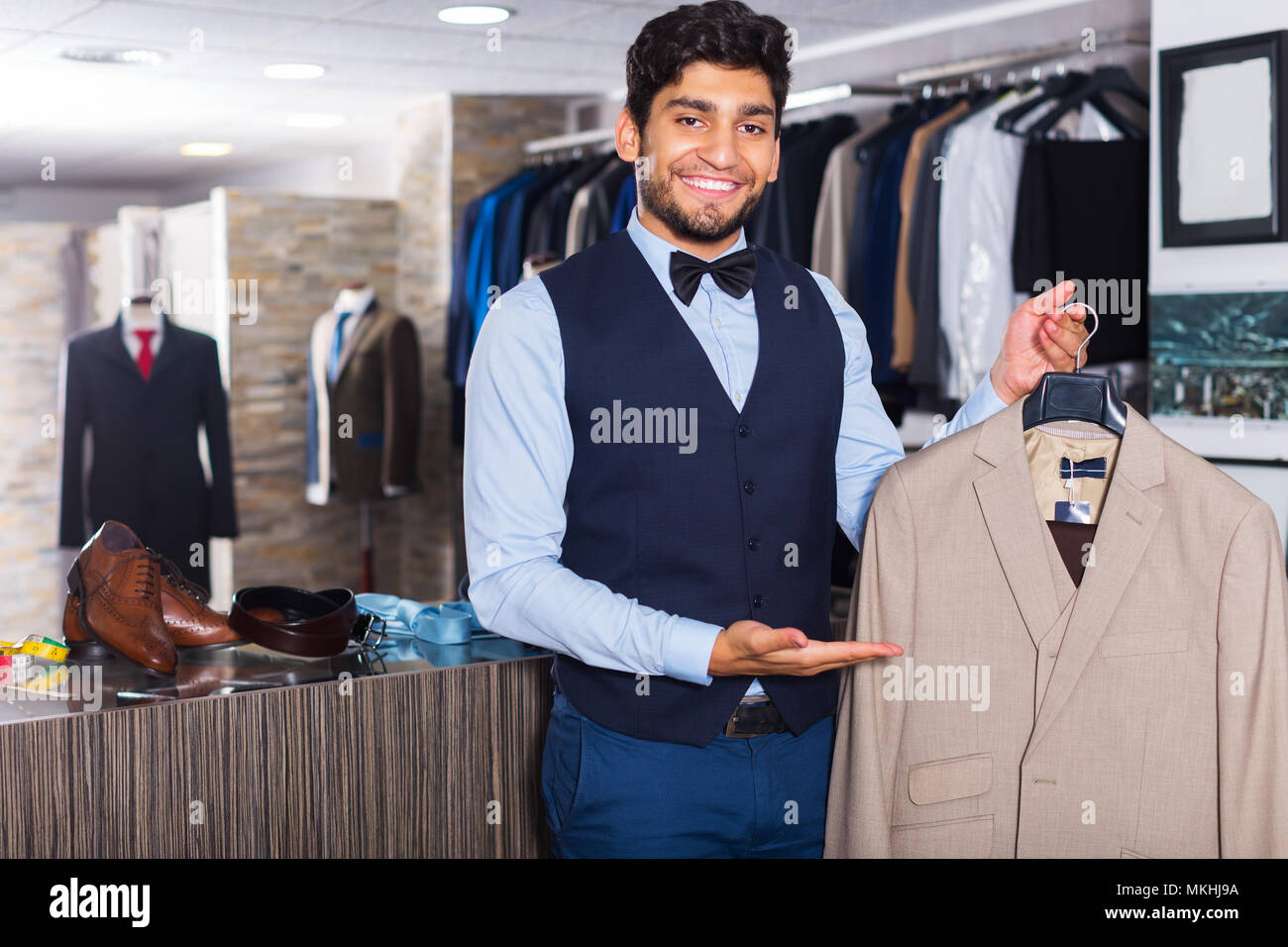 Male customer demonstrating his choice of suit in apparel store Stock ...