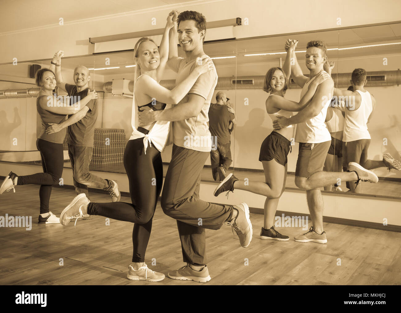 Young men and women dancing the salsa o bachata in dance hall Stock ...