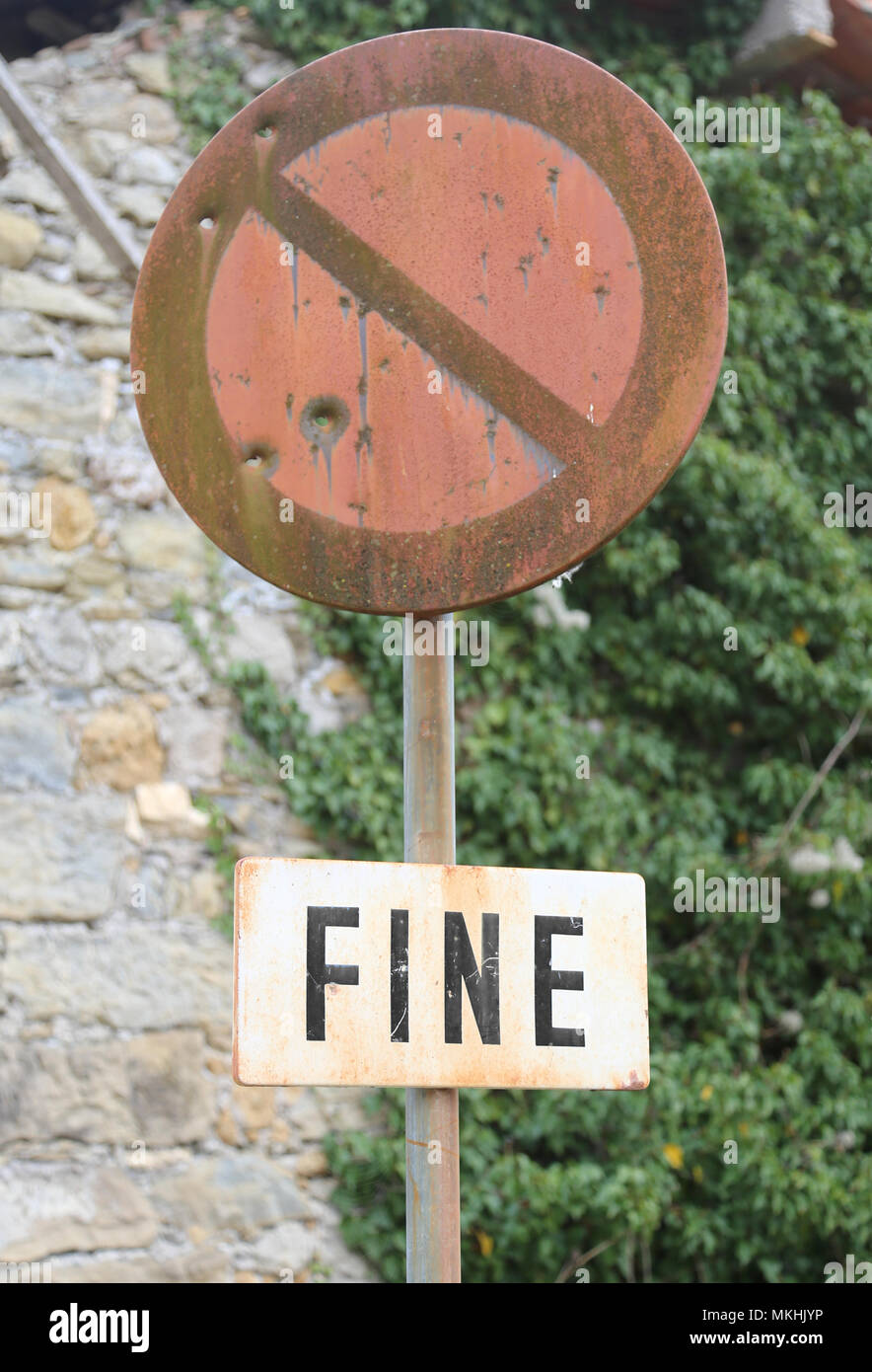 Text FINE that means END in Italian Language on a broken road sign ...