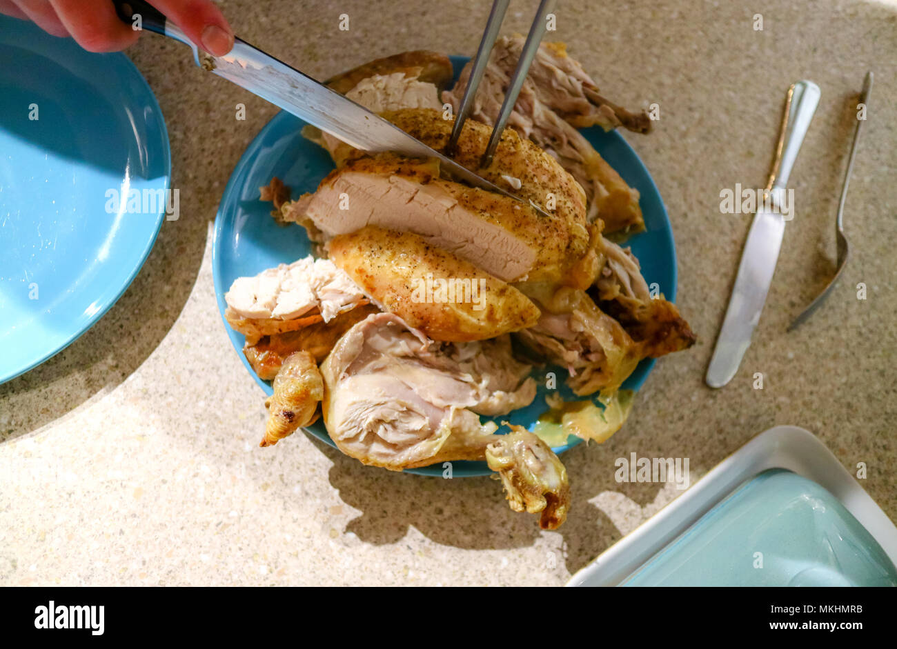 Side view of a freshly roasted chicken being carved Stock Photo - Alamy