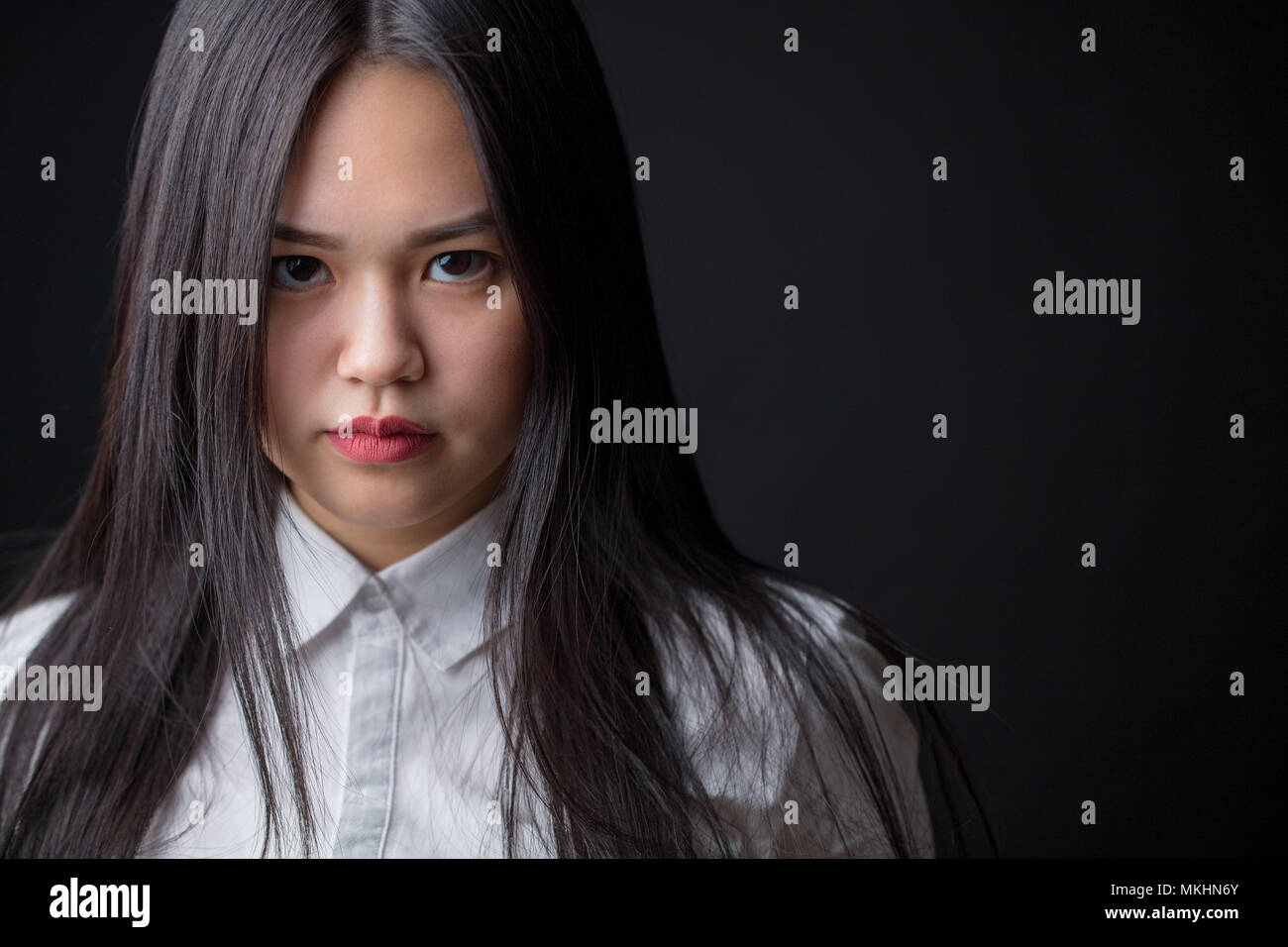 Portrait of appealing young asian woman with beautiful piercing eyes ...