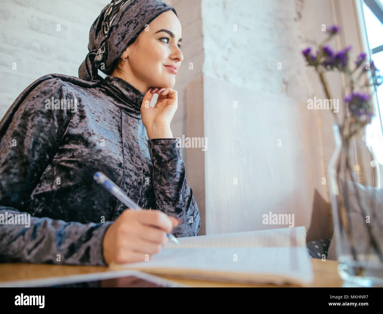 Muslim woman writing love diary in cafe Stock Photo - Alamy