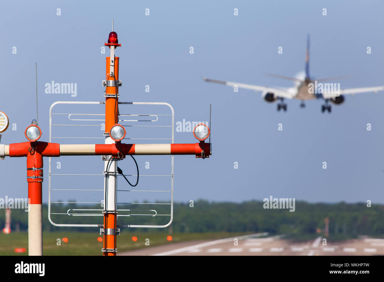 airplane landing with airport beacons in daylight Stock Photo - Alamy