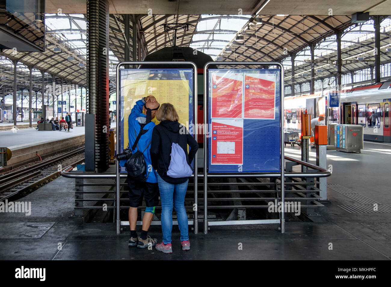 People checking timetables at the Zurich HB Main Station, Zurich ...