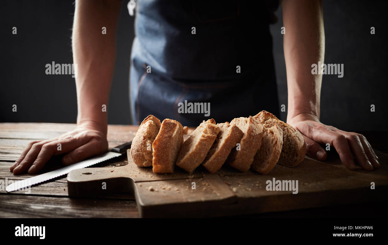 Whole grain bread put on a kitchen plate with a chef Stock Photo - Alamy