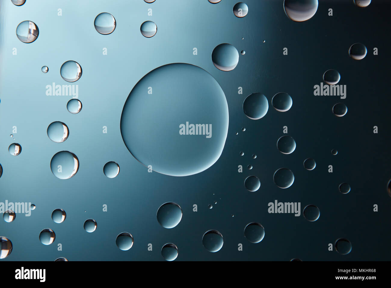 blue big and and small water drops on the glass Stock Photo - Alamy