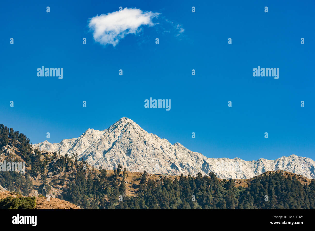 A distant view of Dhauladhar Mountain ranges during a sunny day. Triund ...