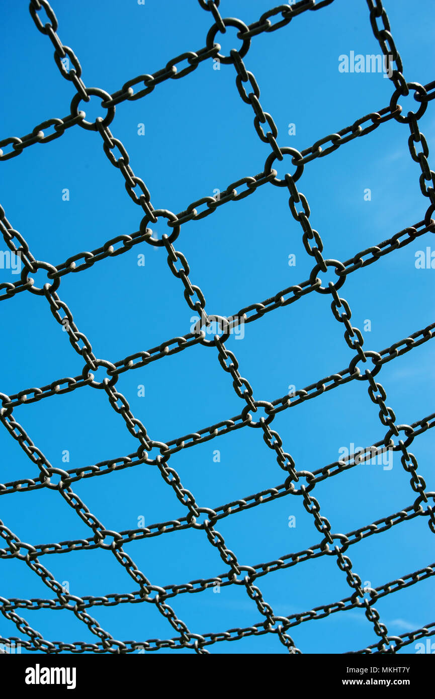 Chains of a soccer goal with blue sky Stock Photo - Alamy
