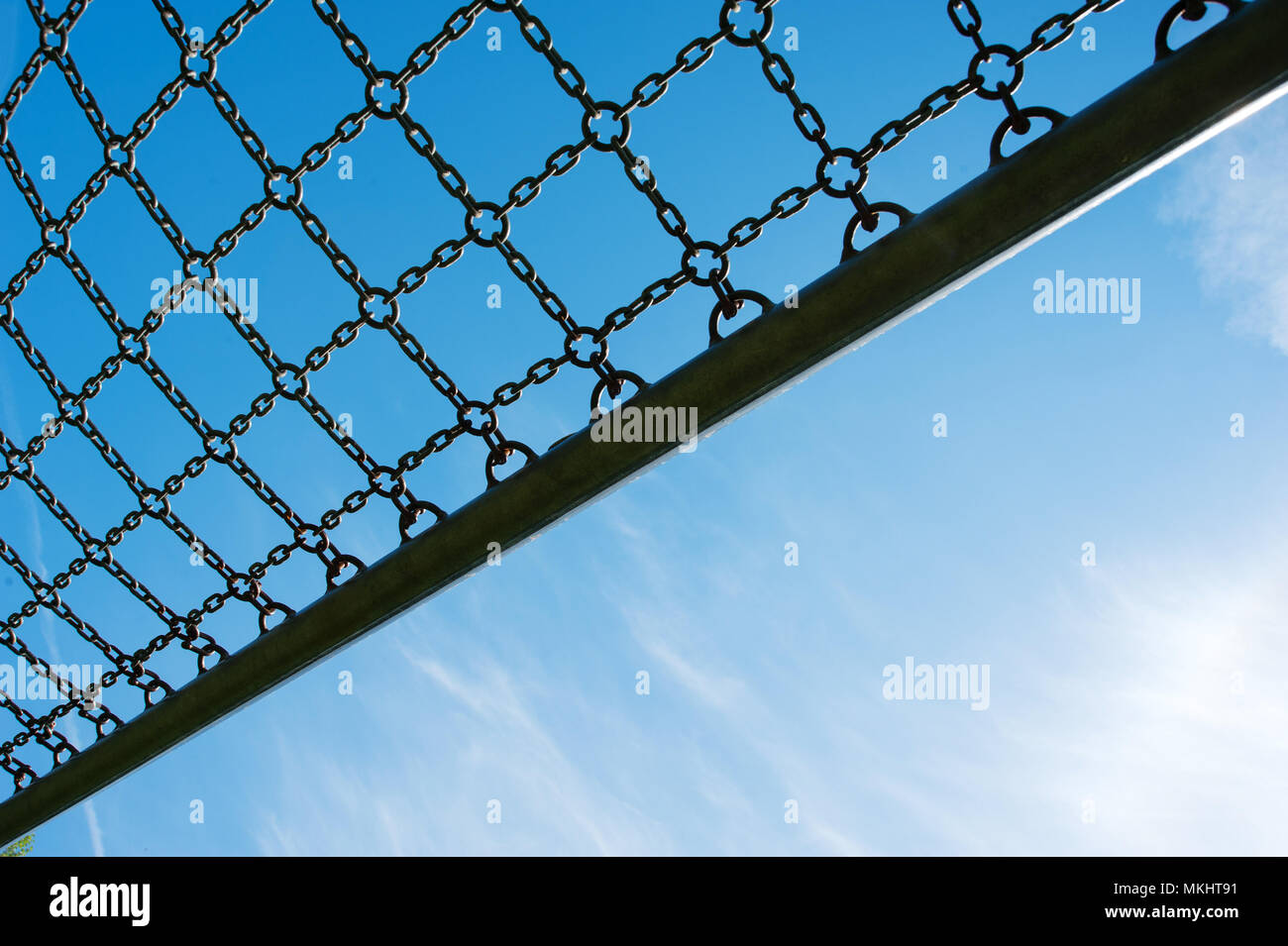Chains of a soccer goal with blue sky Stock Photo - Alamy