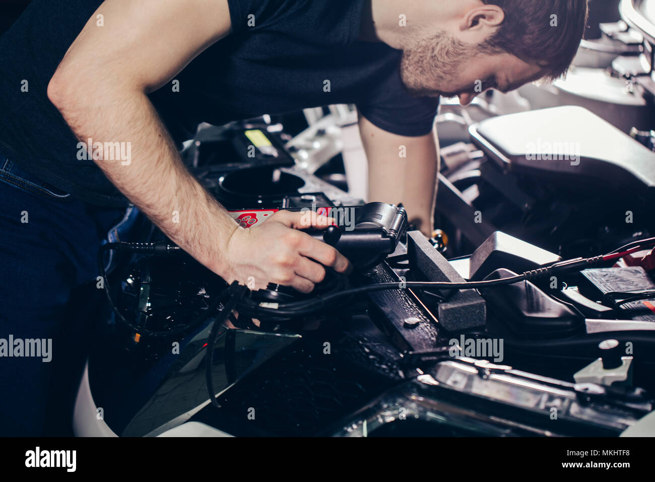 Auto mechanic testing electrical system on automobile Stock Photo - Alamy