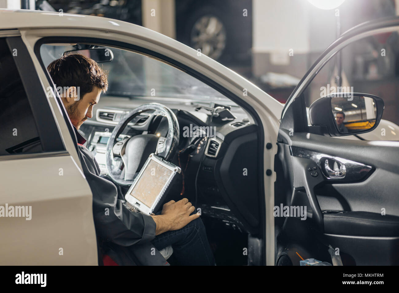 mechanic using special laptop computer to check car engine Stock Photo ...